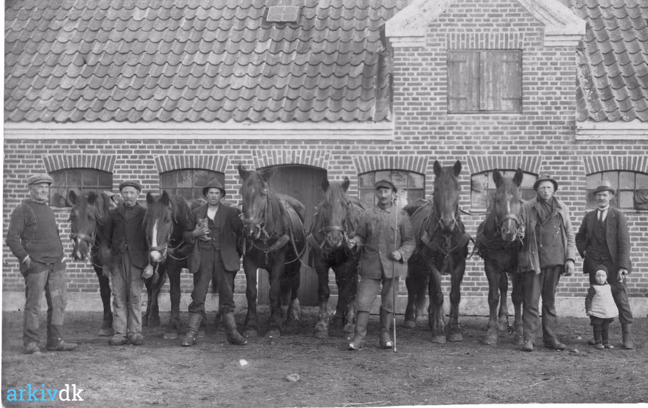 arkiv.dk | Tyendekarle og gaardejer Andreasen, Andreas Theodor med plejesøn stående foran Grove ...